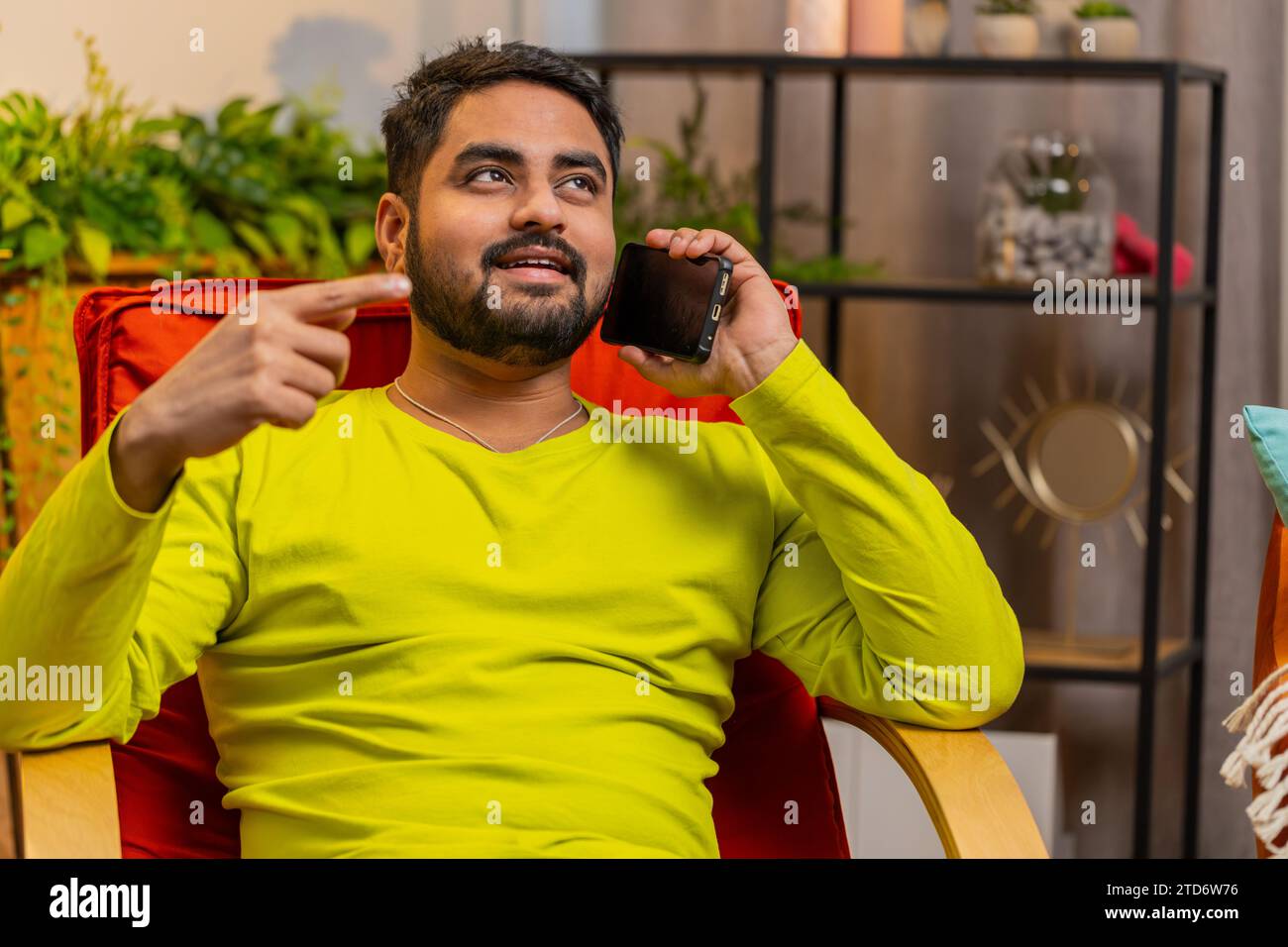 Phone call, good news, gossip. Happy surprised Indian man having ...