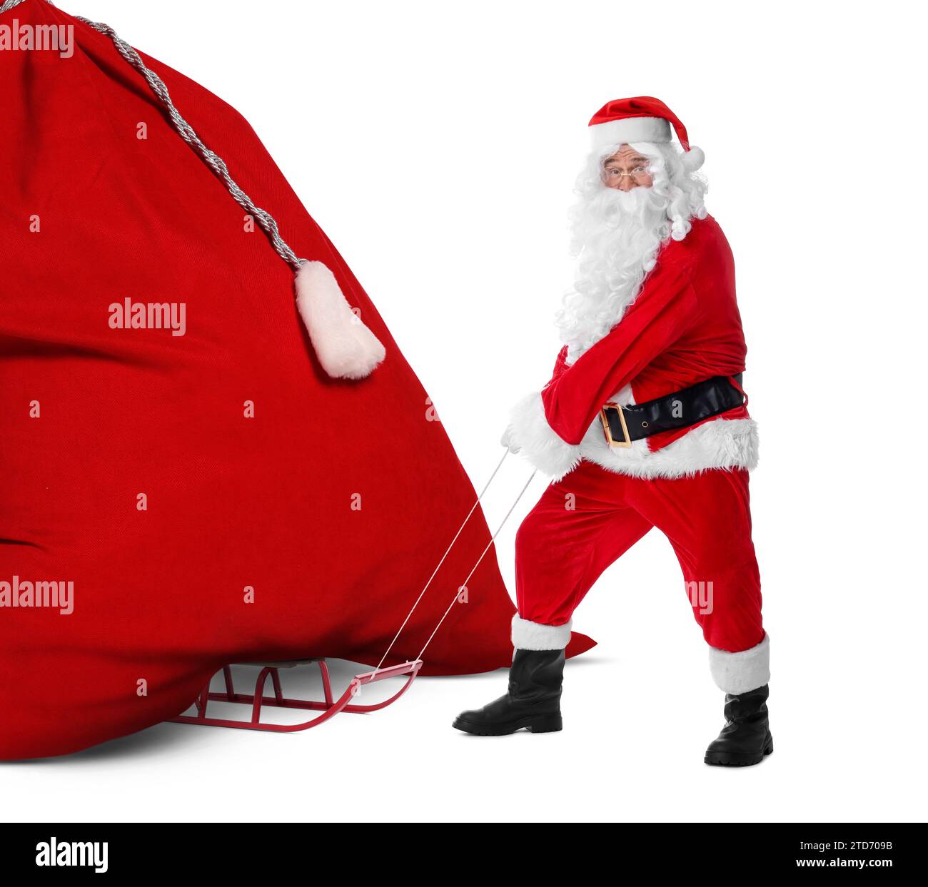 Santa Claus with big red bag full of Christmas presents on sled against ...