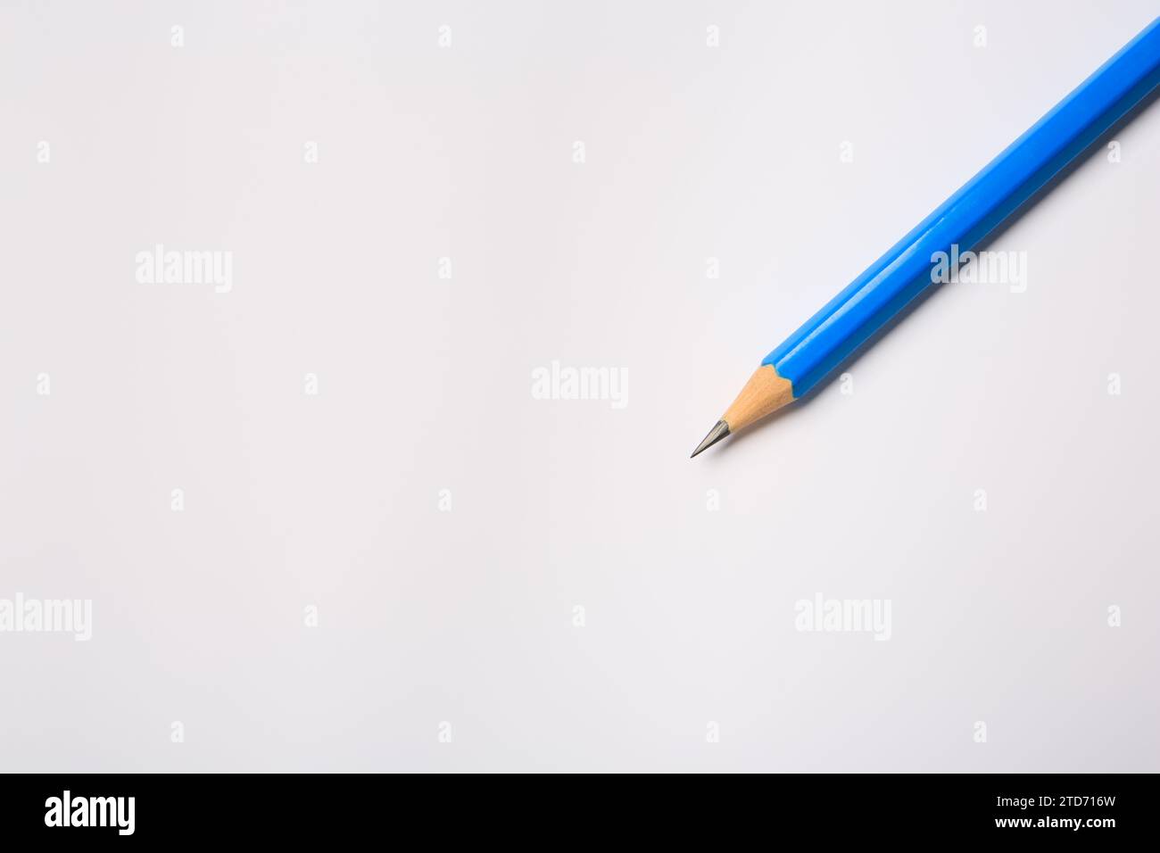 Sharp graphite pencil on white background, top view. Space for text ...