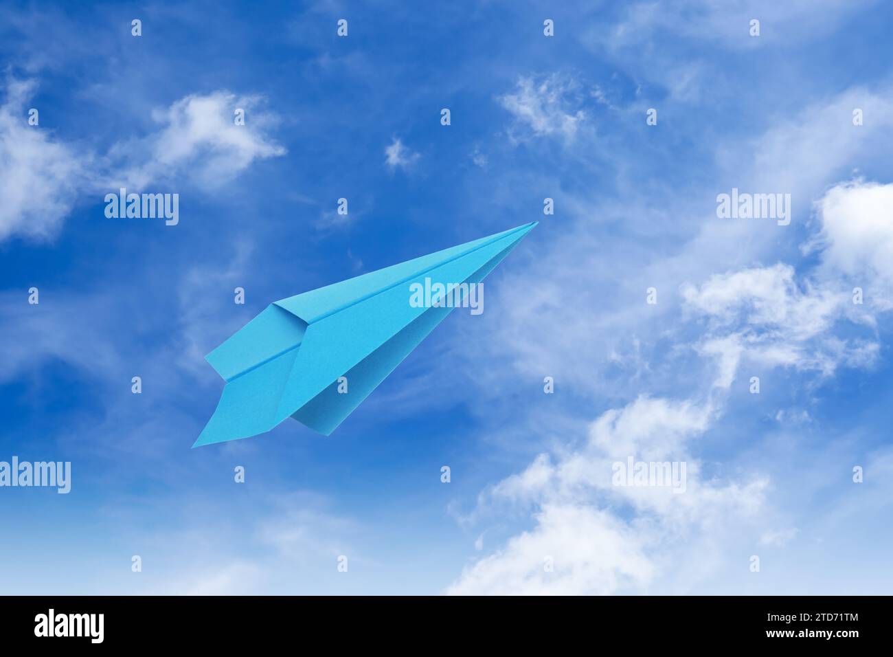 Light blue paper plane flying in sky with clouds with clouds Stock ...