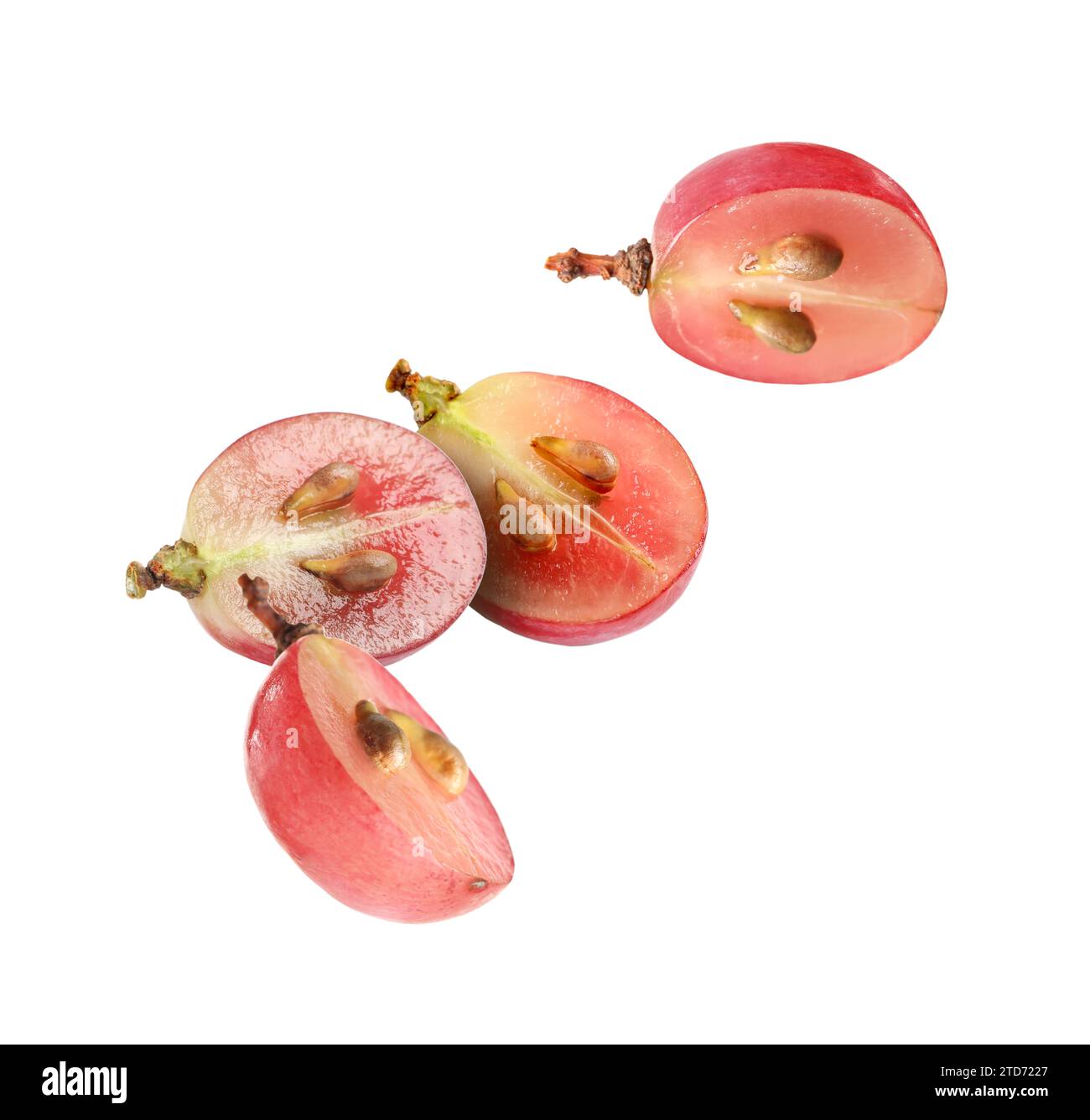 Halves of fresh grape falling on white background Stock Photo - Alamy