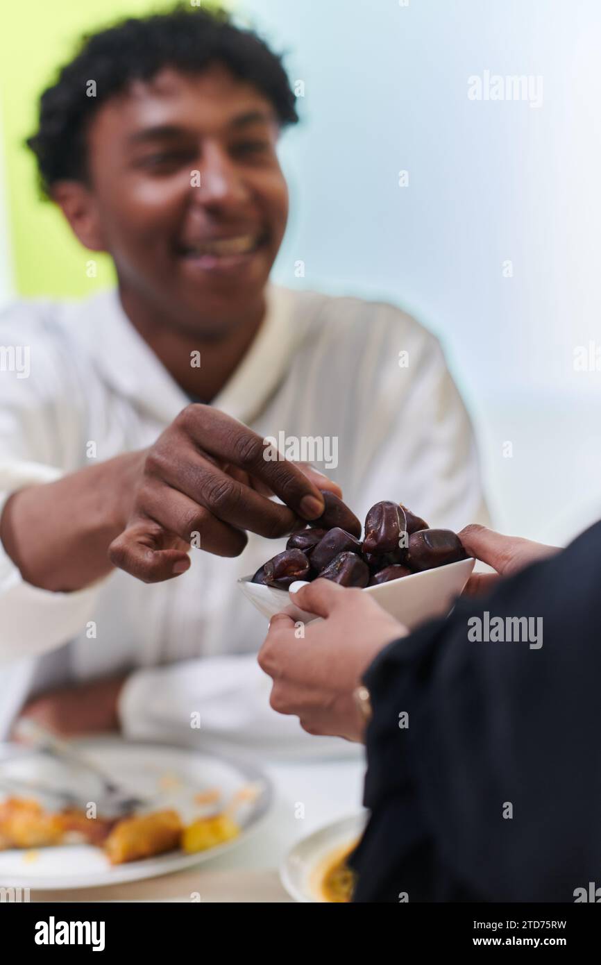 African American Muslim man delicately takes dates to break his fast ...