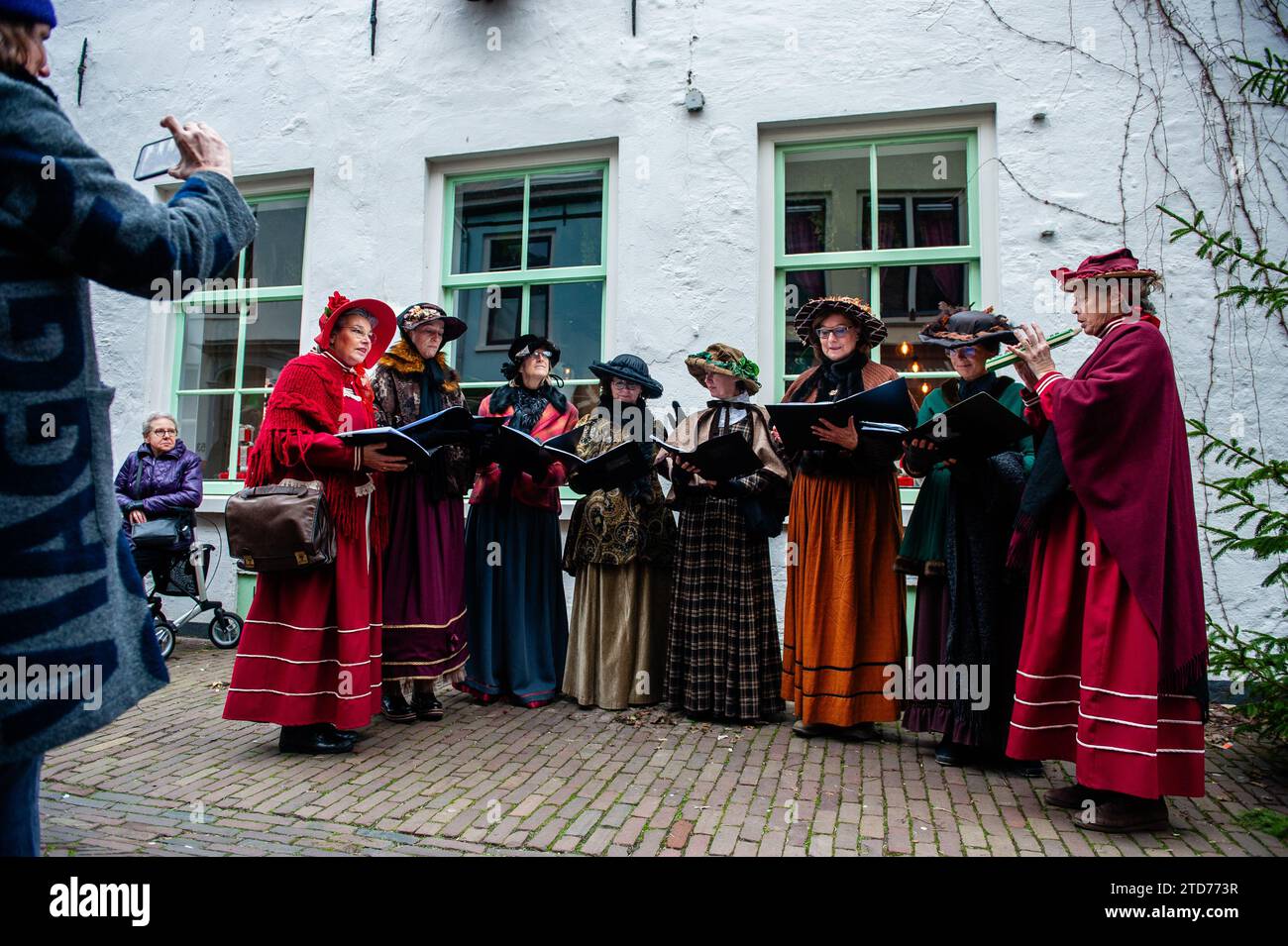 A female choir performs while wearing Victorian dresses. Each year ...