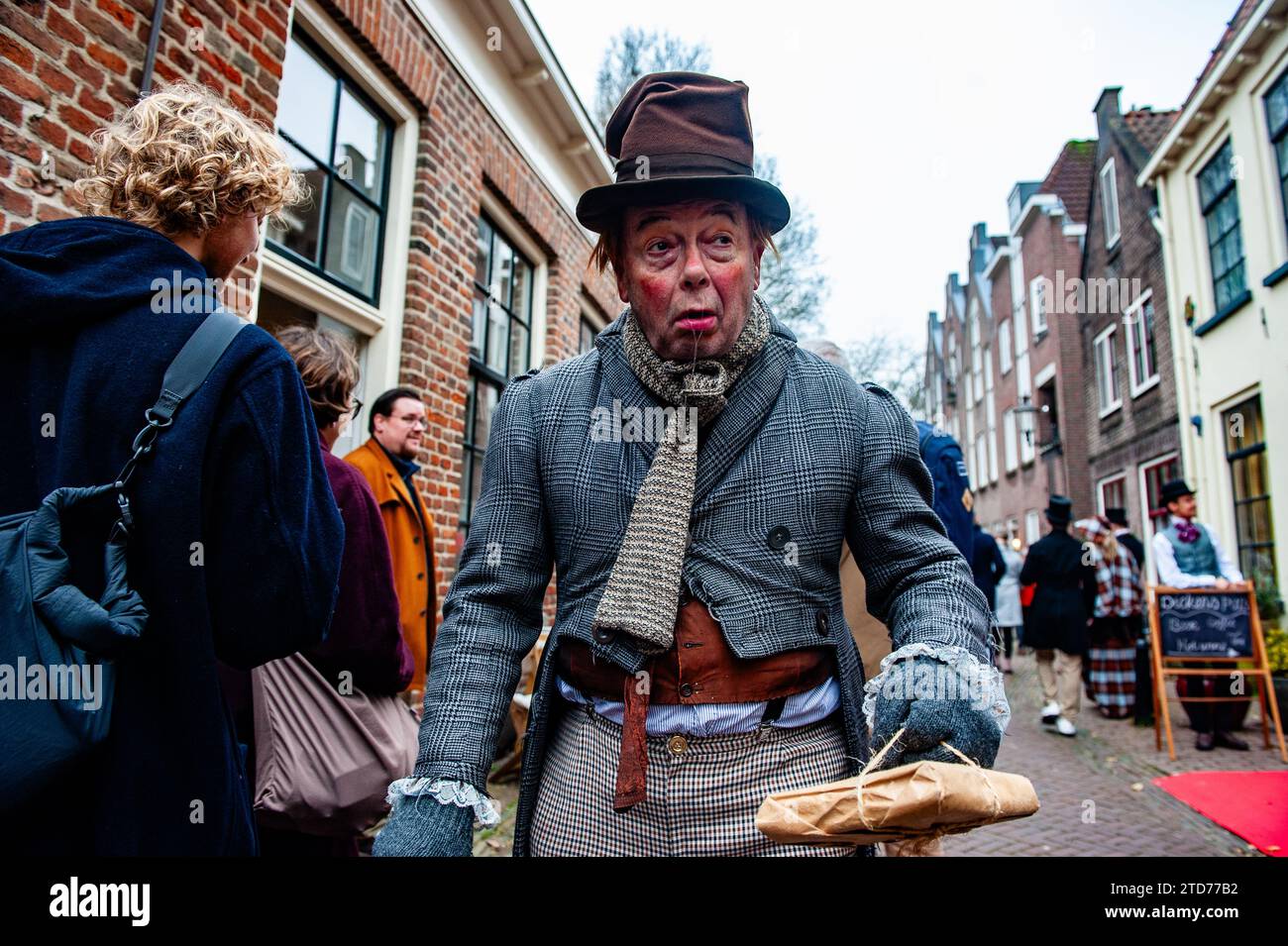 Deventer, Netherlands . 16th Dec, 2023. A man performs as a homeless ...