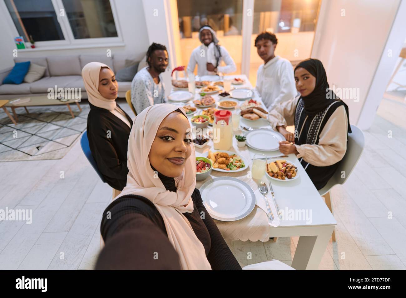 A traditional Muslim family captures the joy of their shared iftar meal ...