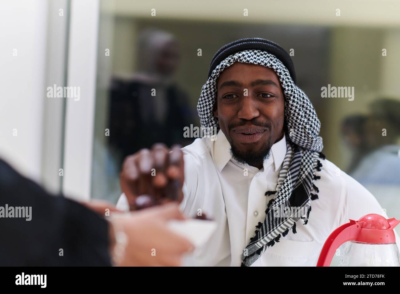 African American Muslim man delicately takes dates to break his fast ...