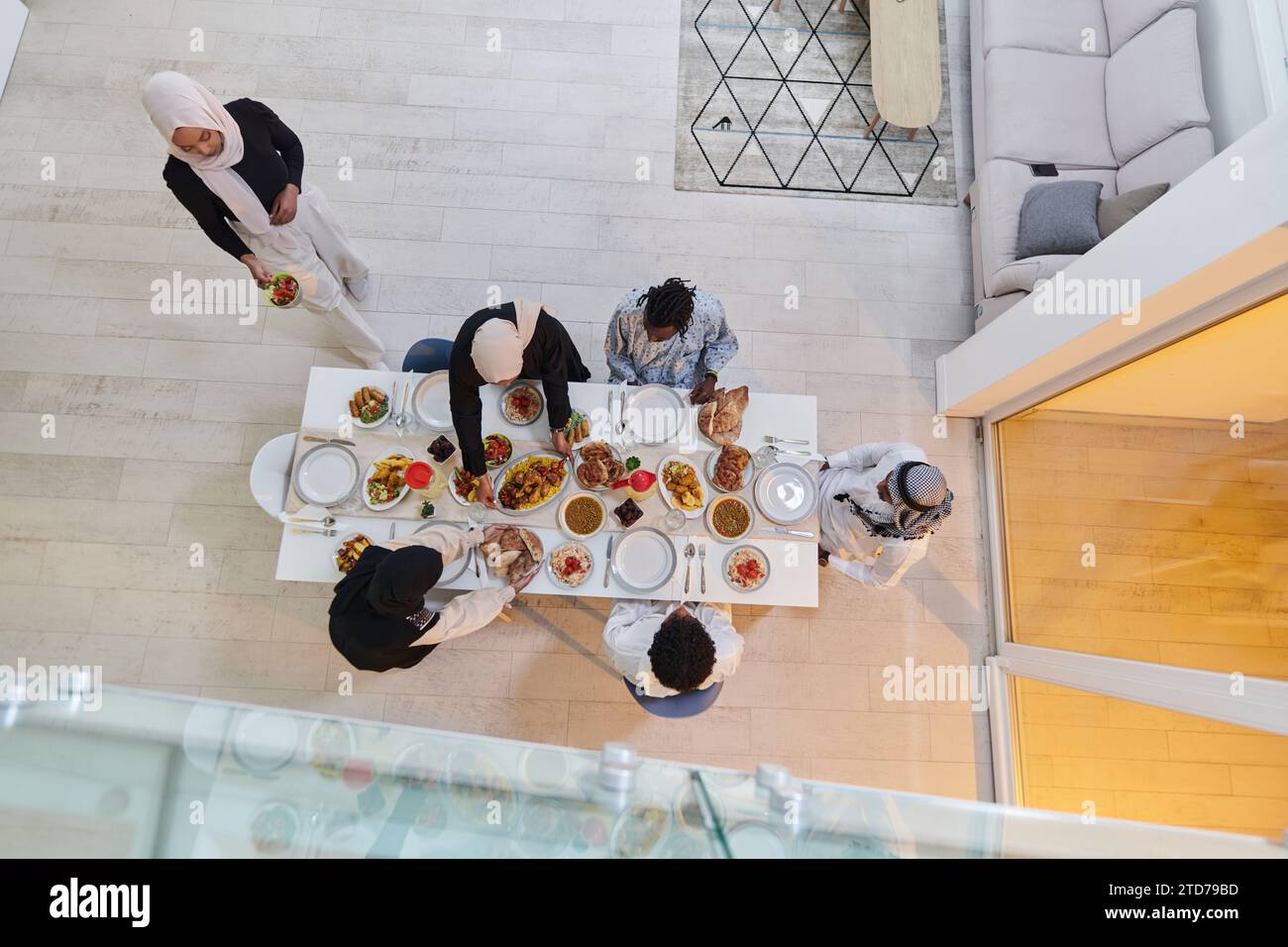 Top view of a Muslim family joyously comes together around a table ...