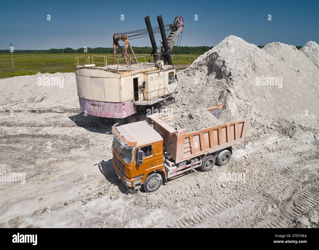 Tipper truck and Shovel mining excavator in mining quarry Stock Photo ...