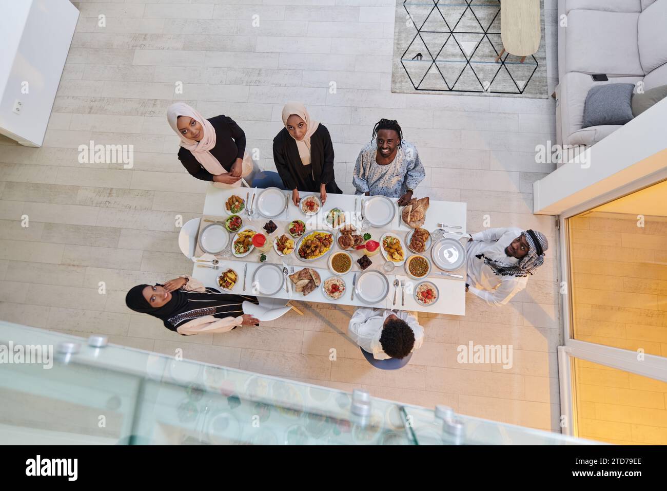 Top view of a Muslim family joyously comes together around a table ...