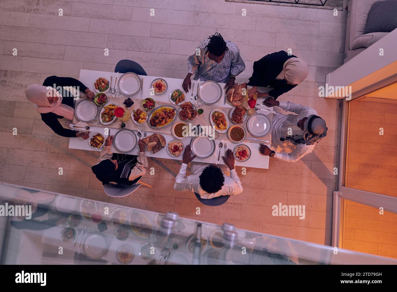 Top view of a Muslim family joyously comes together around a table ...
