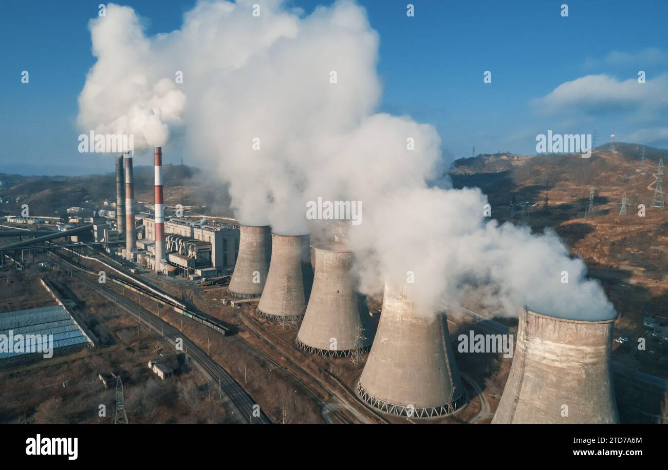Aerial view of an industrial zone pipes pouring thick white smoke ...