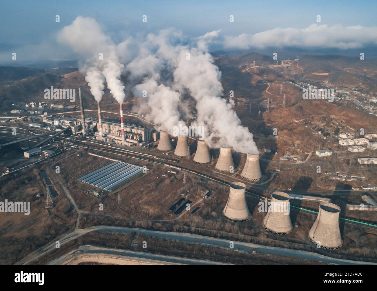Aerial view of tall chimney pipes with grey smoke from coal power plant ...