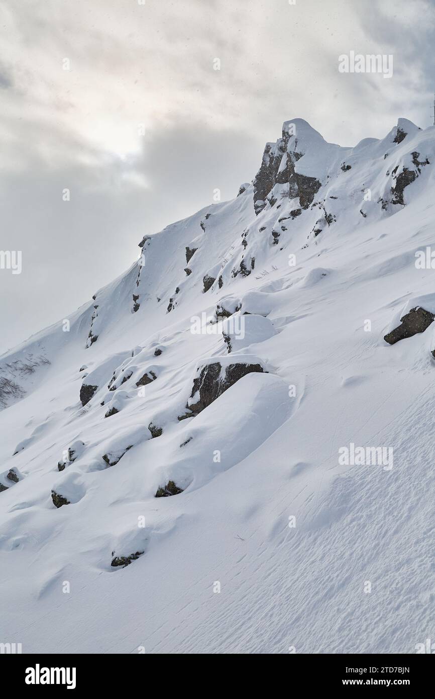Snowy mountains with falling snow Stock Photo - Alamy