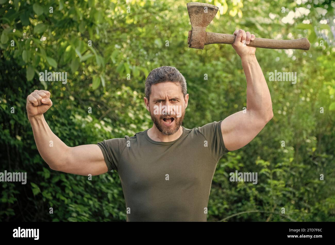 aggressive man hold axe outdoor. photo of aggressive man with axe ...