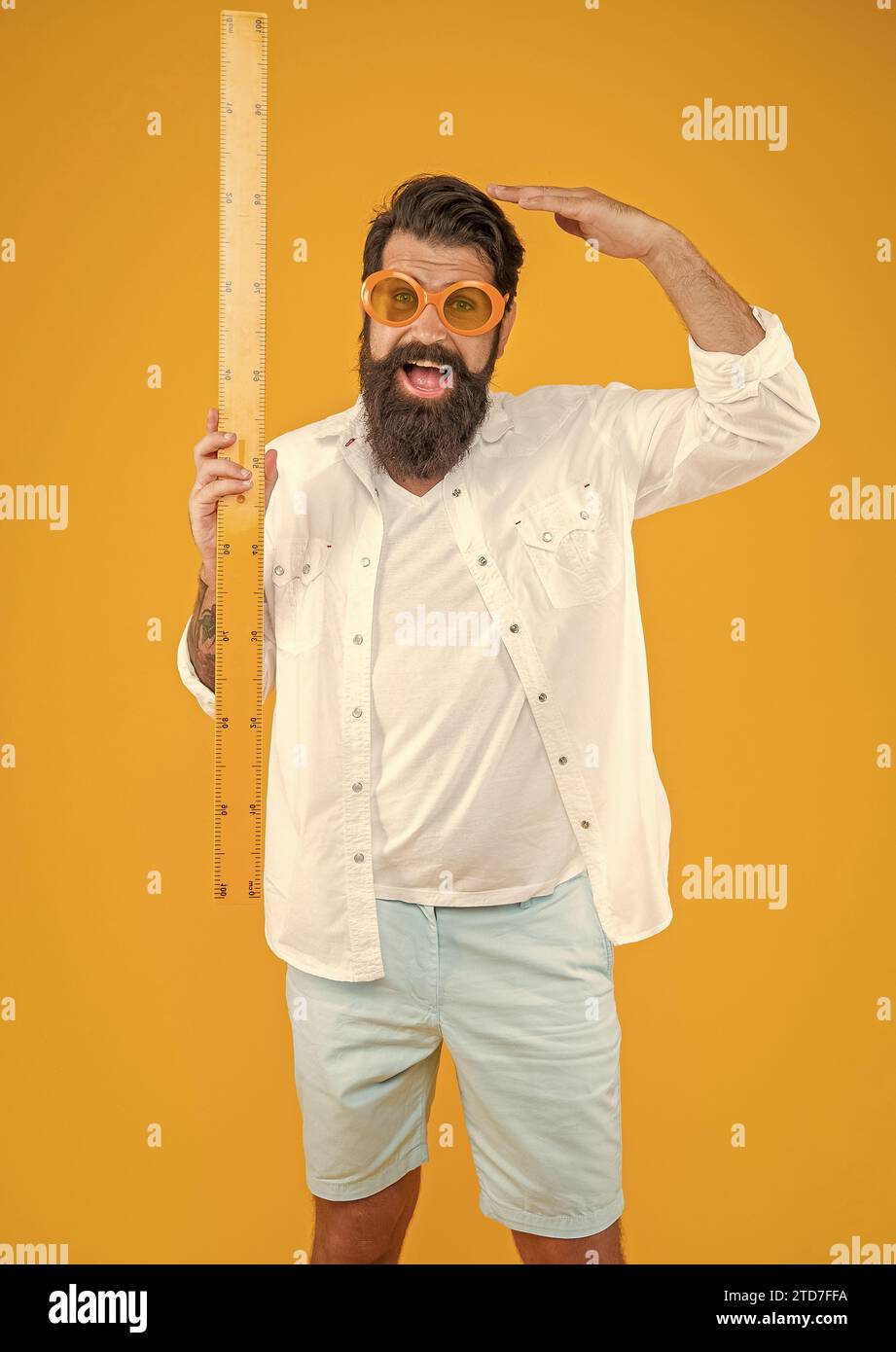man hold measuring ruler shocked with height on background Stock Photo ...