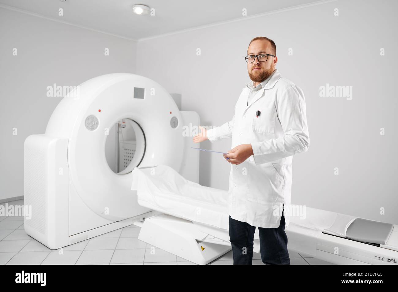 Portrait of doctor with medical computed tomography or MRI scanner ...