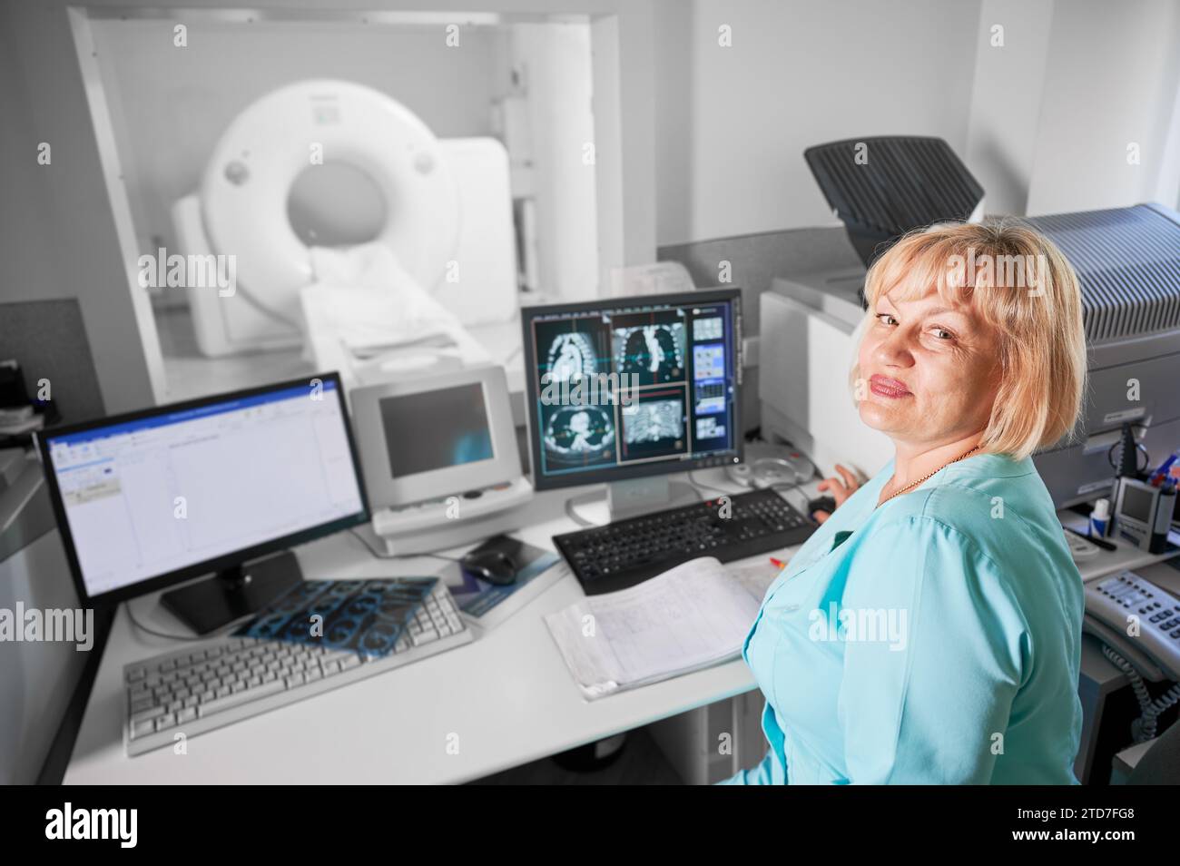 Medical computed tomography or MRI scanner. Portrait of female nurse ...