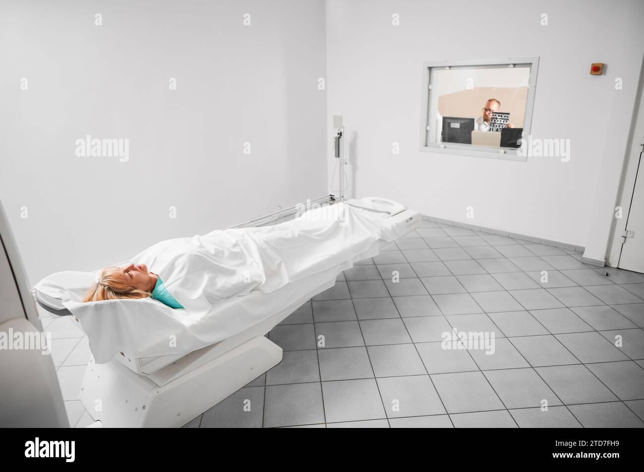 Medical computed tomography or MRI scanner. Female patient lying on ...