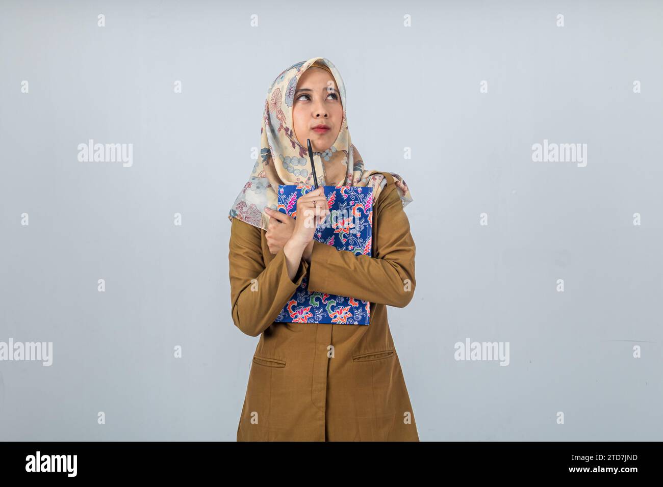 Young Indonesian Woman government employee wearing a brown uniform ...