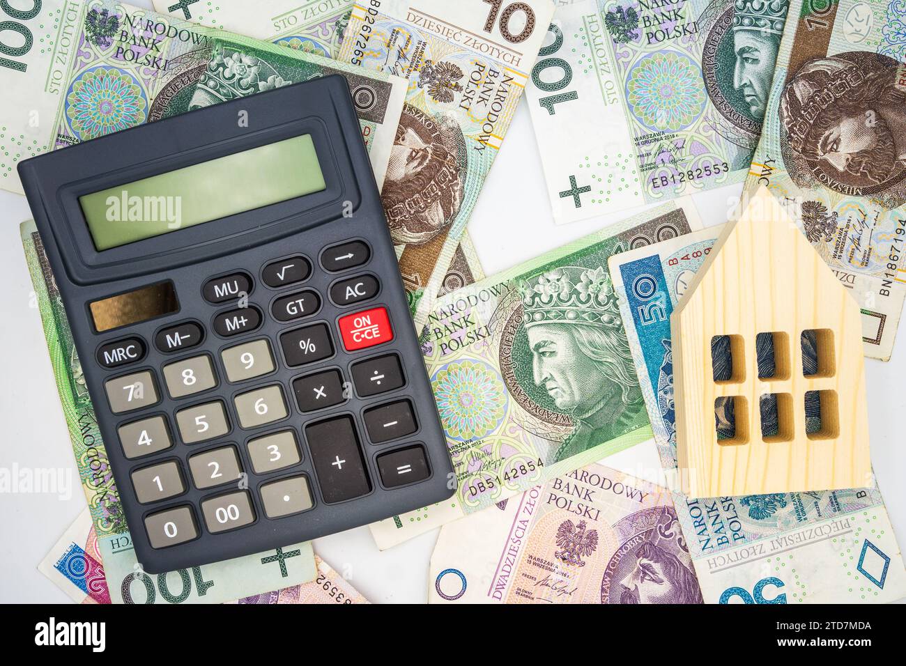 Polish zloty banknote wooden house and calculator background currency ...