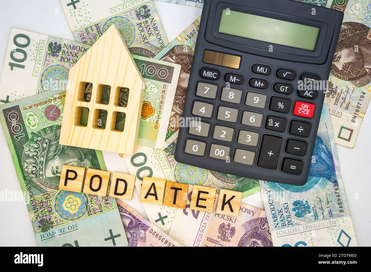 Polish word "podatek" tax with wooden house Polish zloty banknote ...