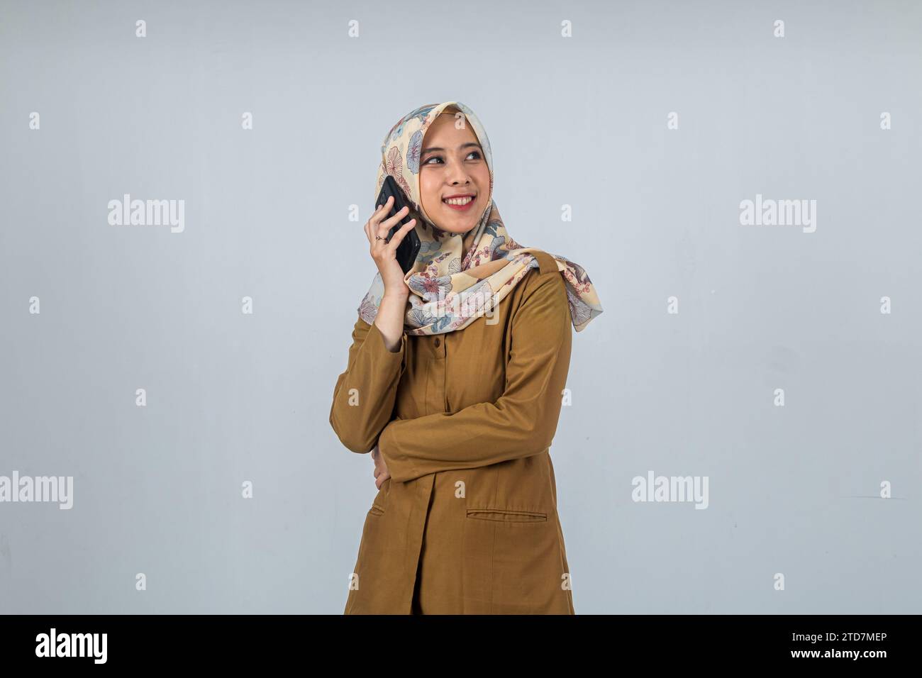 Young Indonesian Woman government employee wearing a brown uniform ...