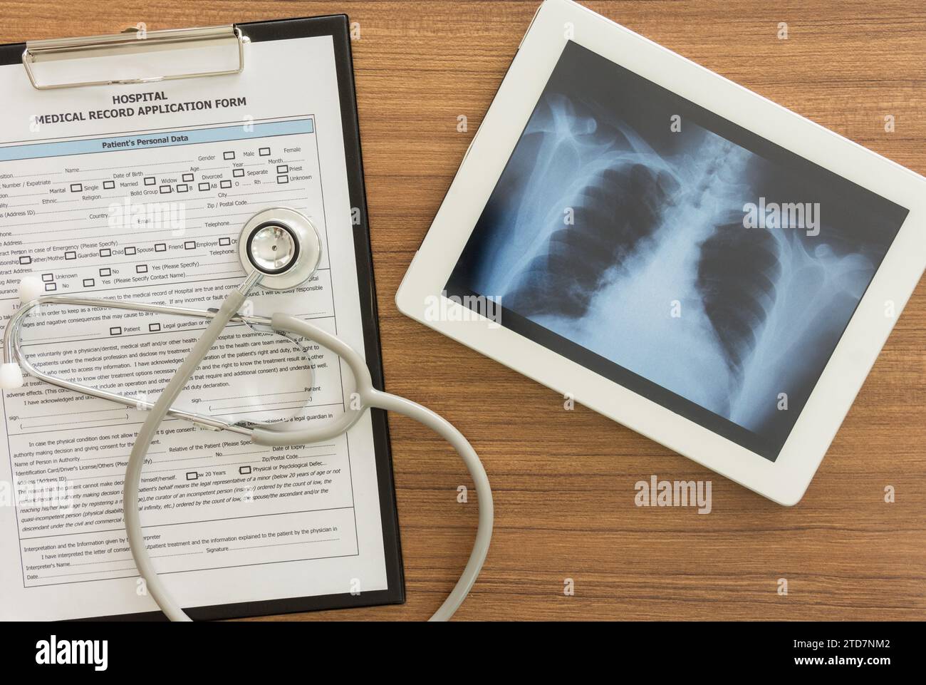 x-ray lung image in tablet computer, stethoscope, medical document on ...