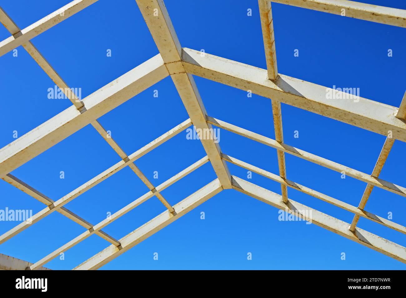 A metal structure made of square and rectangular pipes against the ...