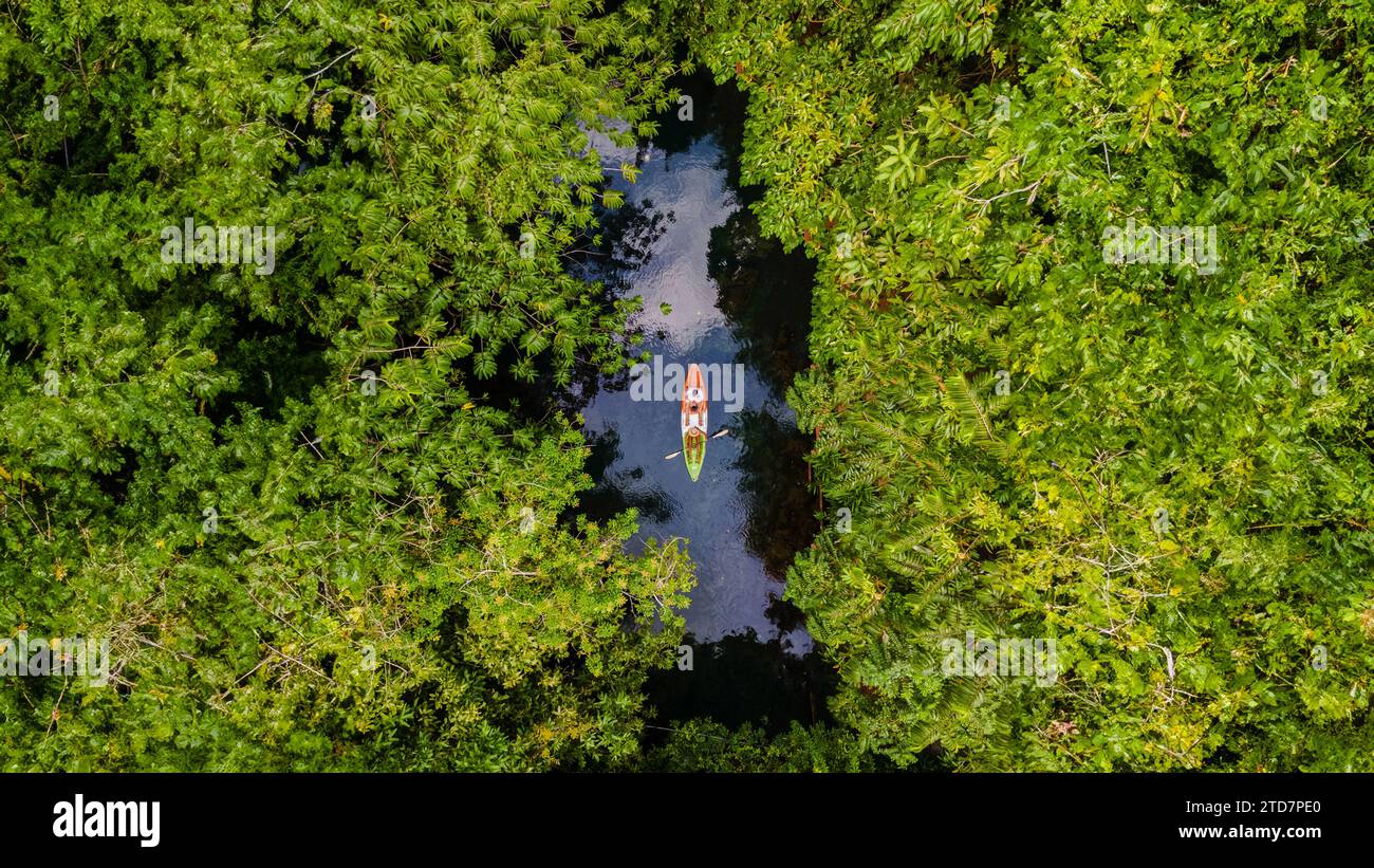 couple in a kayak in the jungle of Krabi Thailand, men and women in a ...