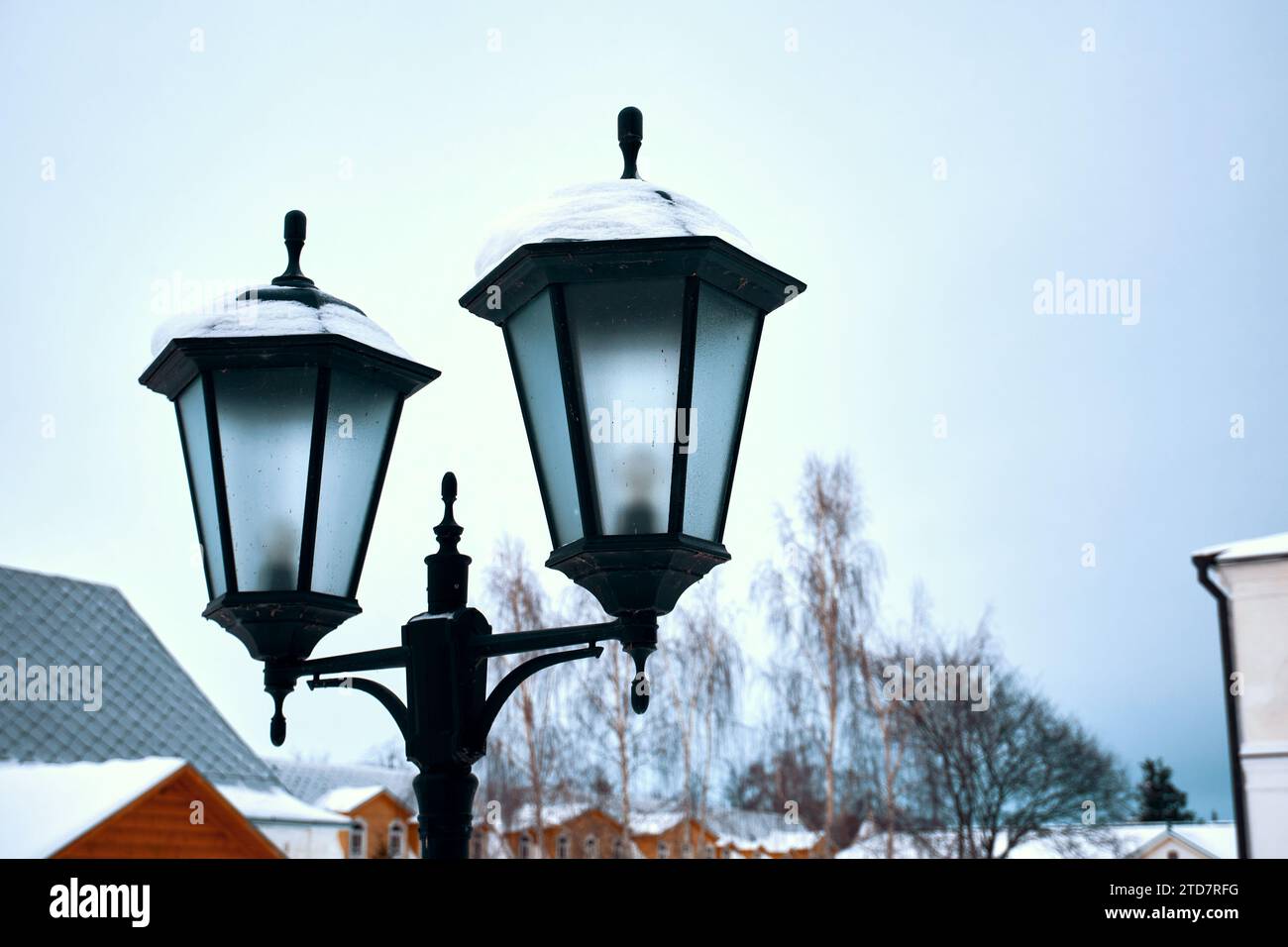 Street lamp close-up during the day against the backdrop of a winter ...