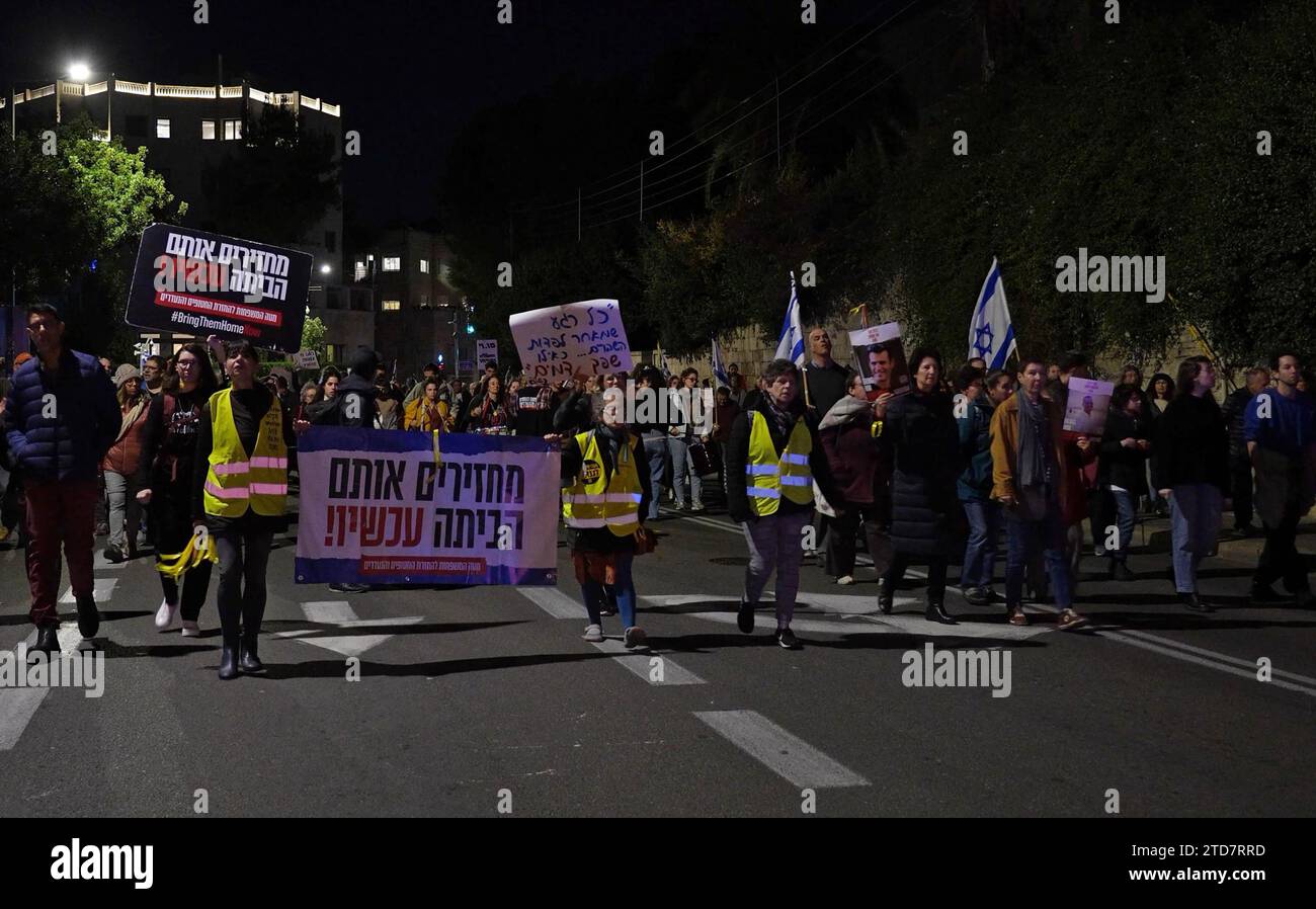 Protesters hold signs as they march during a demonstration calling for ...