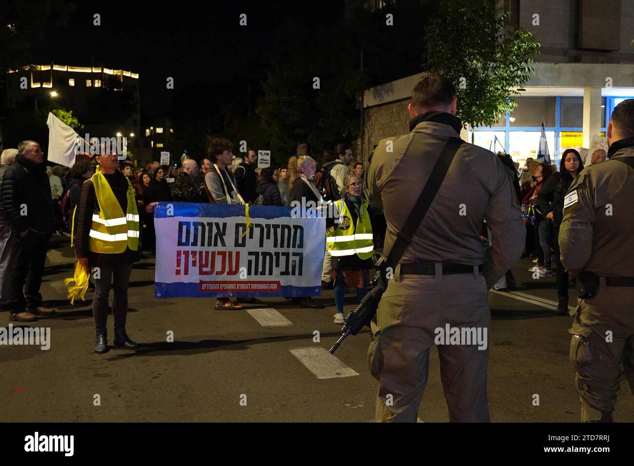 Members of the Israeli security force watch over as protestors gather ...