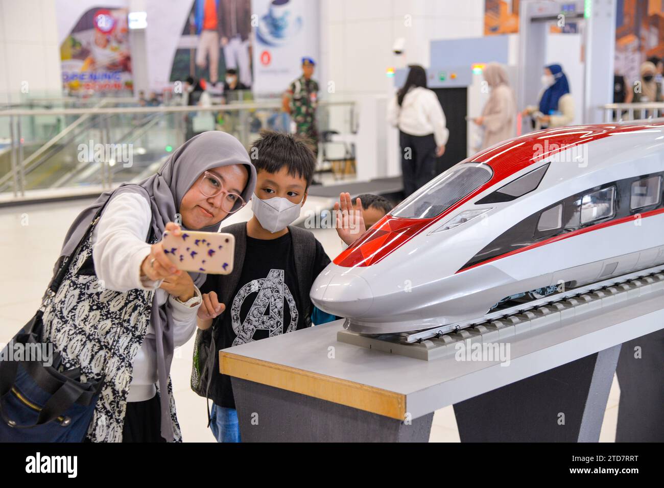 Jakarta, Indonesia. 17th Dec, 2023. Passengers take a selfie with a model of a high-speed ...