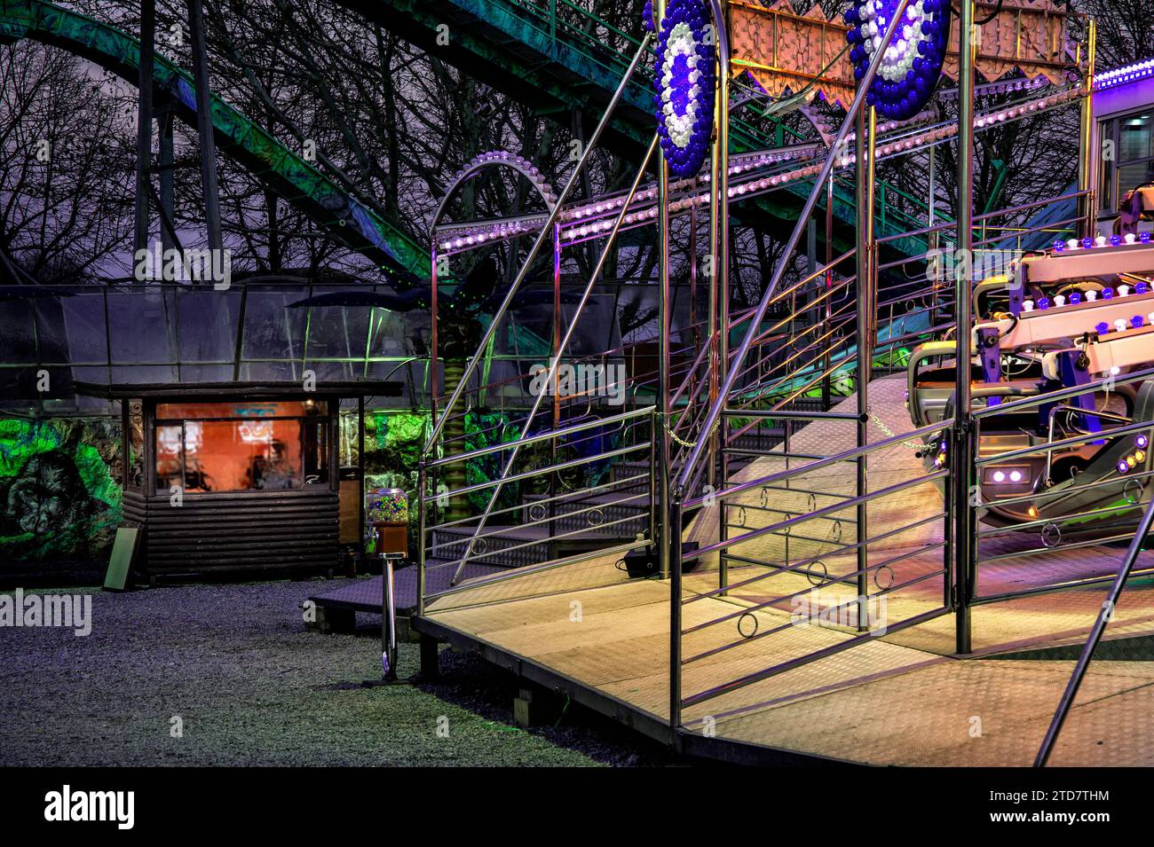View, panorama of funfair, amusement park at night with vivid lights ...