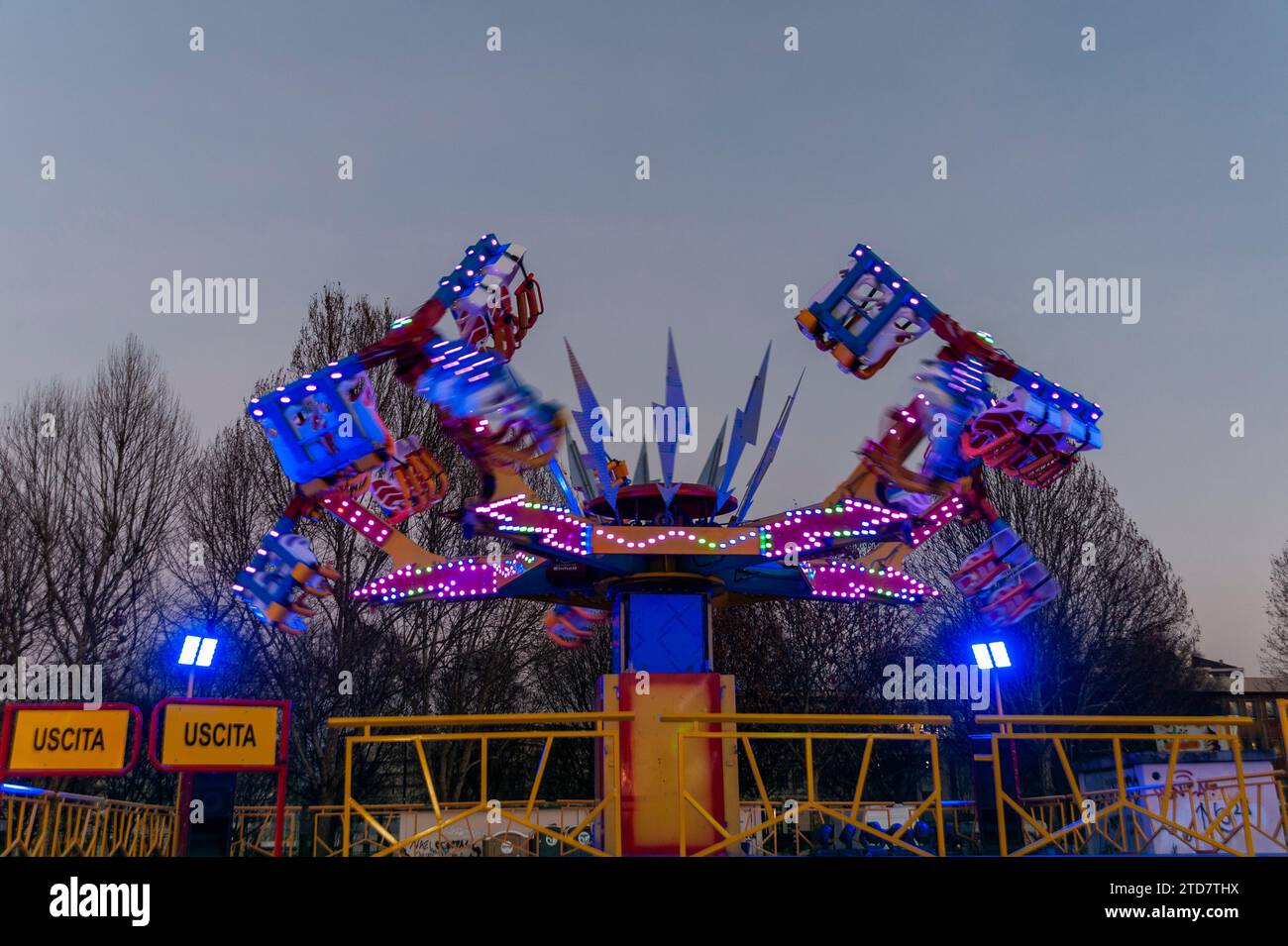 View, panorama of funfair, amusement park at night with vivid lights ...