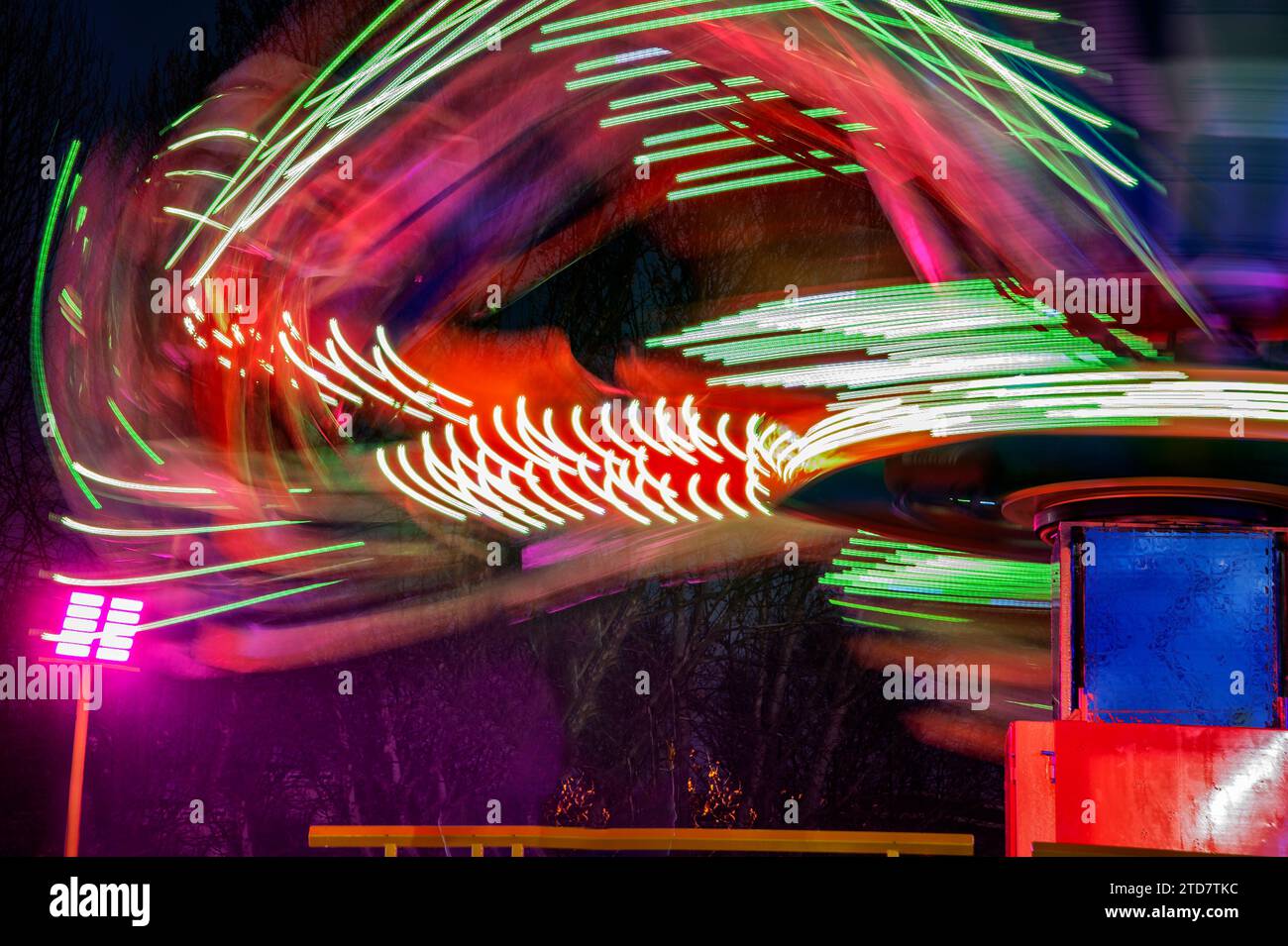 View, panorama of funfair, amusement park at night with vivid lights ...