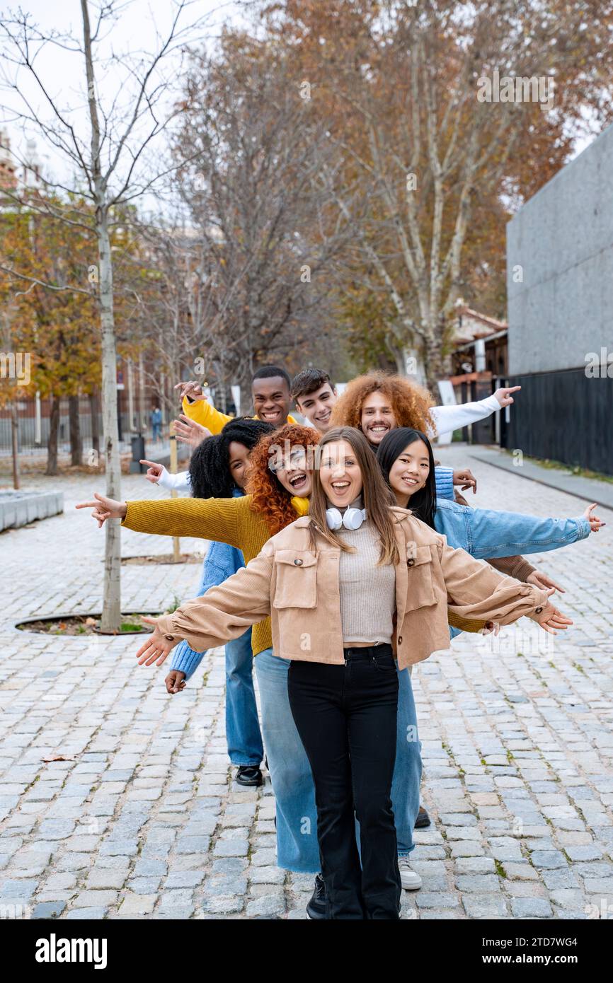 Young multiethnic friends smiling while posing standing in a row with ...