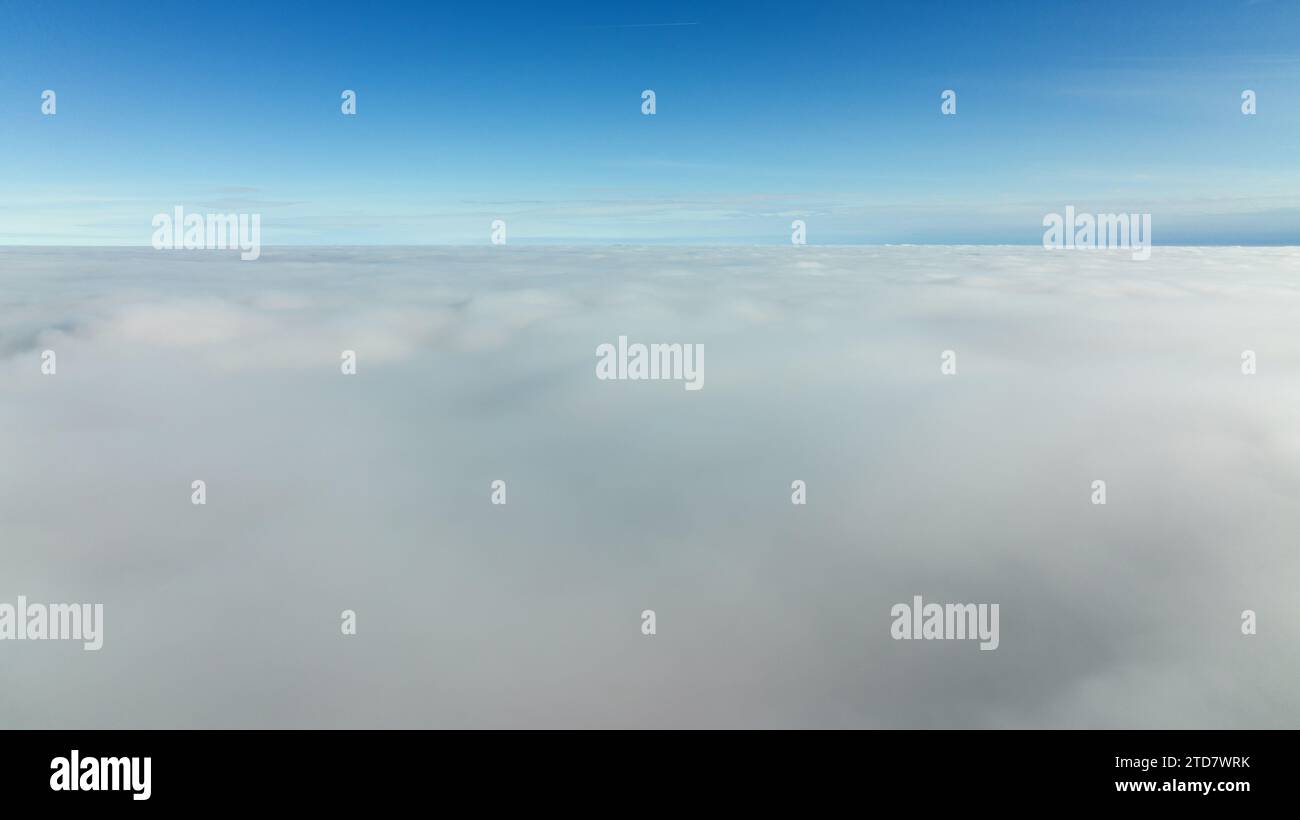 CFlying high above the clouds. Aerial view of clouds and horizon from drone. Thunderclouds from ...