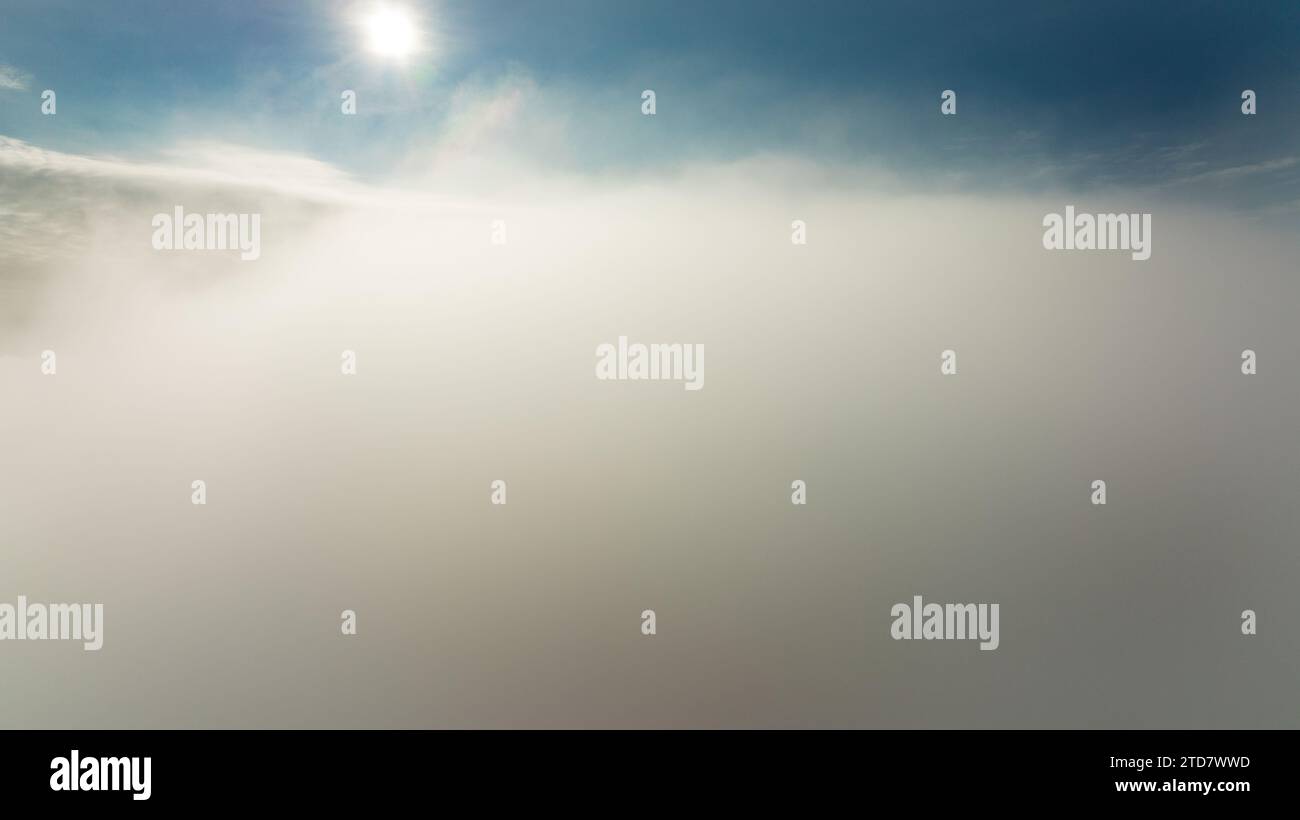 CFlying high above the clouds. Aerial view of clouds and horizon from ...