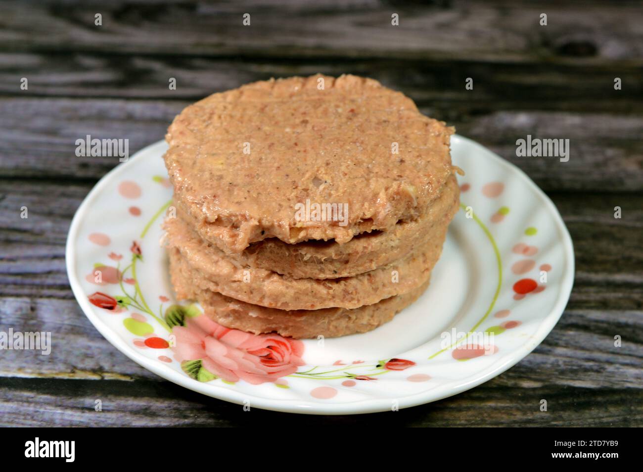 Raw uncooked beef burger ready to be cooked and fried in shallow oil ...
