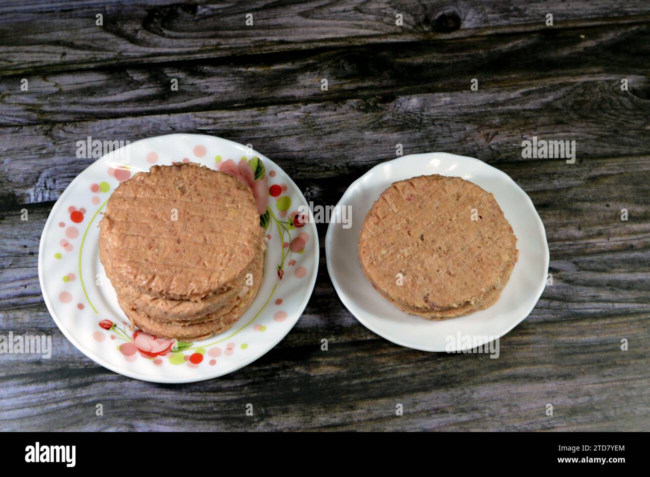 Raw uncooked beef burger ready to be cooked and fried in shallow oil ...