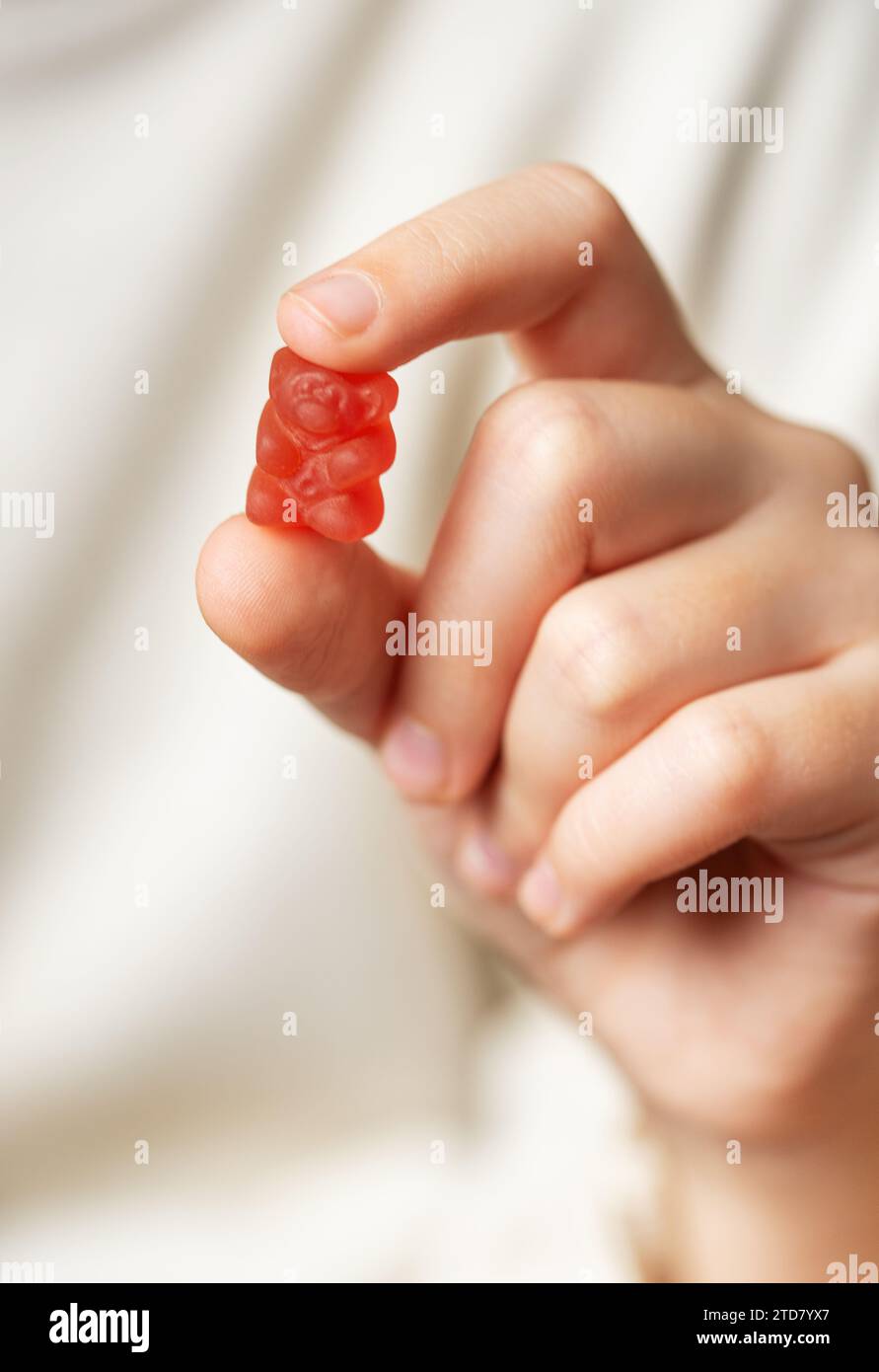 Chewable gummy bears vitamins and supplements. A girl holds a gummy ...