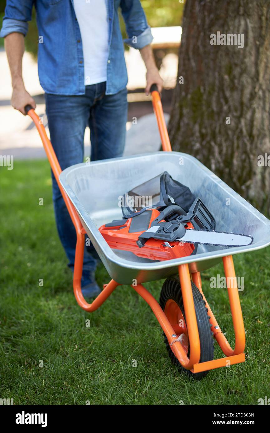 Man using wheelbarrow hi-res stock photography and images - Alamy