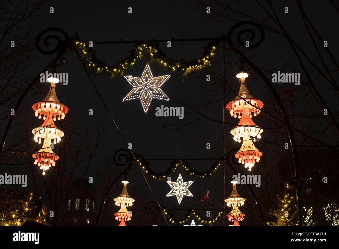 Overhead hanging Christmas lights along one of the wide footpaths in ...