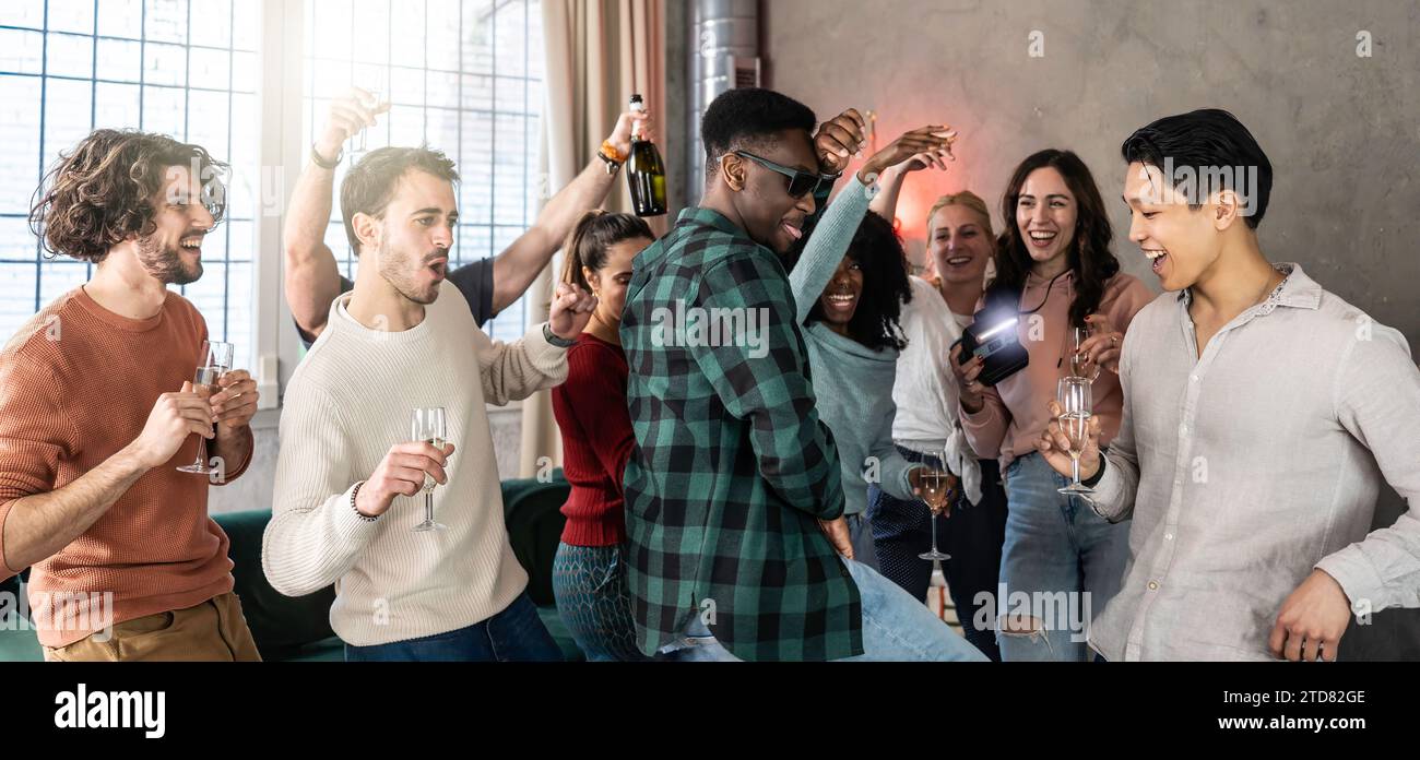 Multi ethnic young friends having home party together - Funny diverse ...