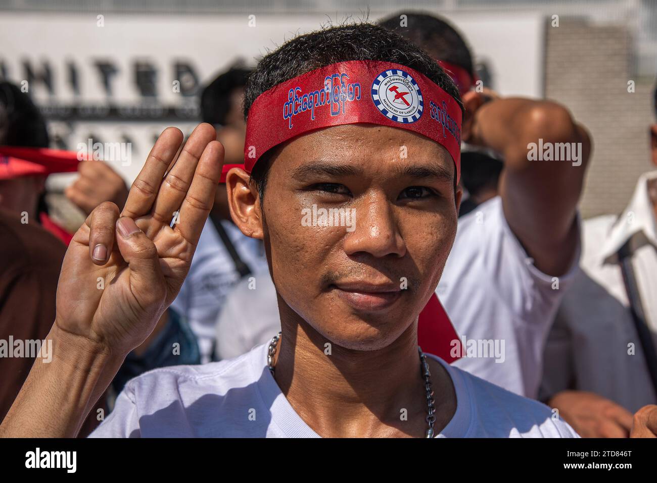 A protester makes three finger salute during the demonstration in front ...