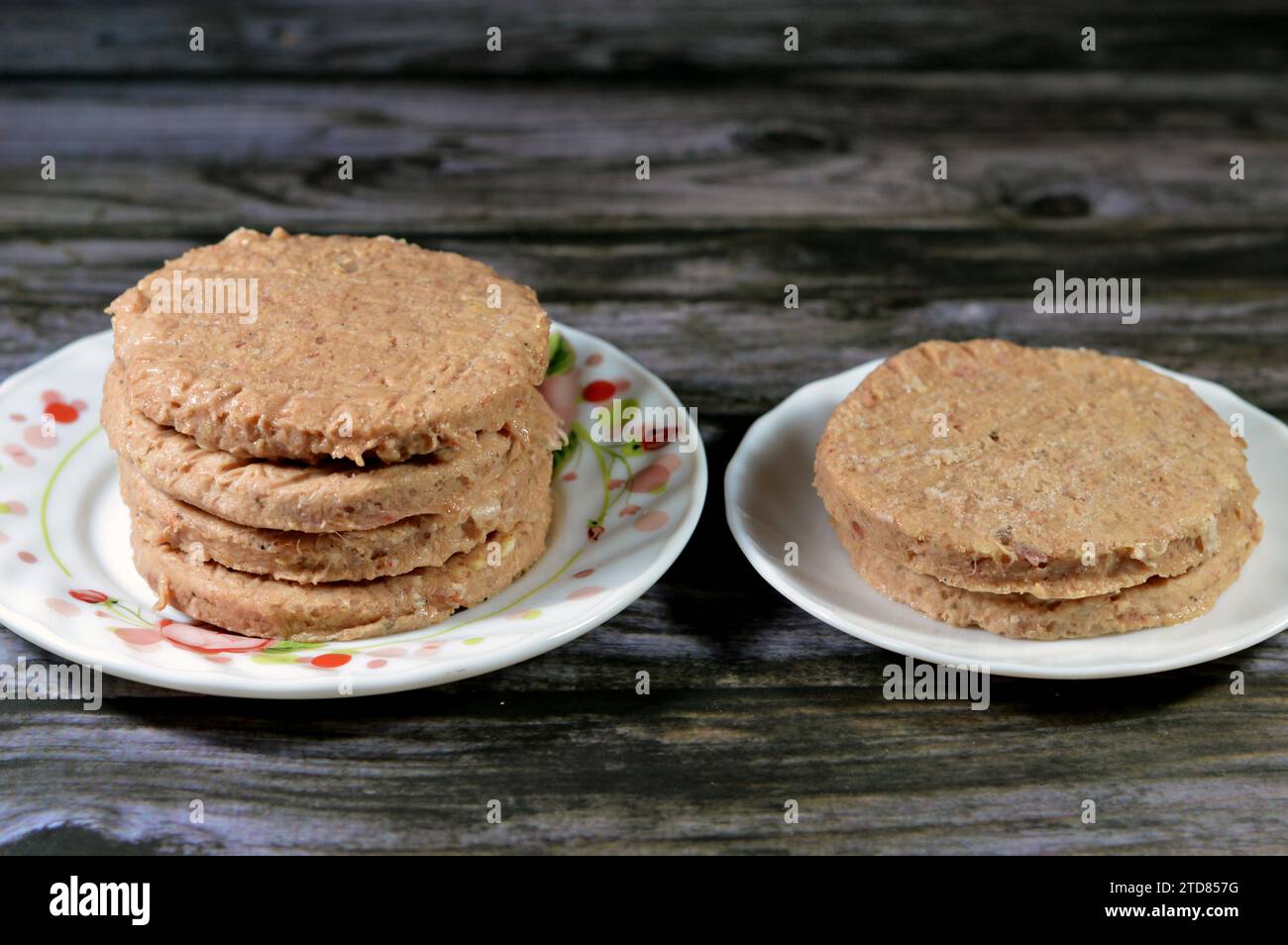 Raw uncooked beef burger ready to be cooked and fried in shallow oil ...