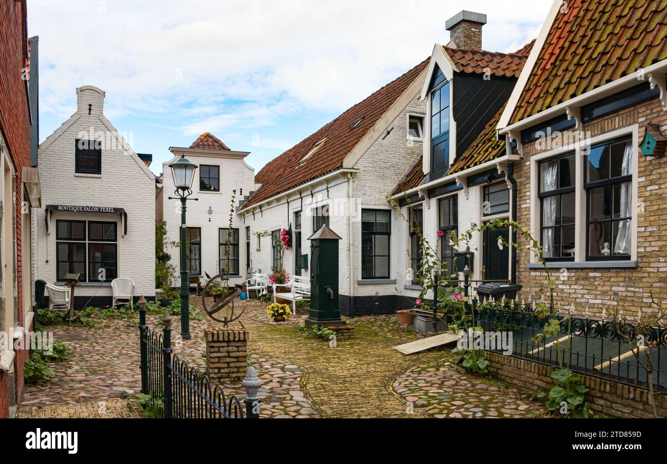 Hofje van Den Burg (courtyard) with historic, picturesque houses. Den ...