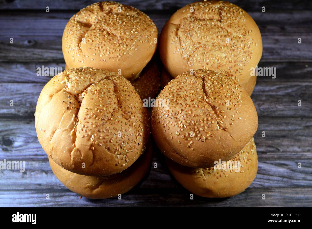 Round hand sized hamburger burger bun baked and covered with sesame ...