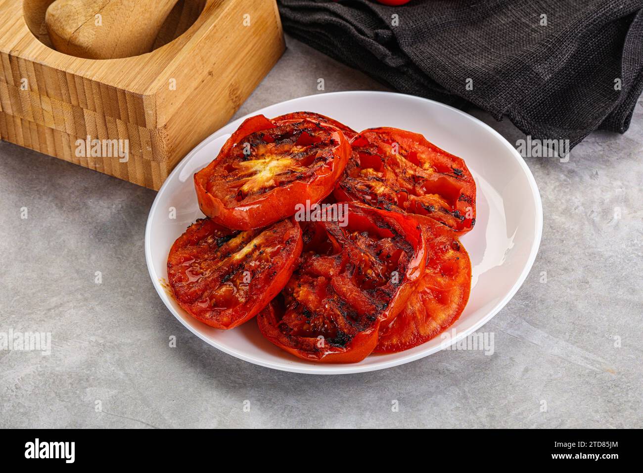 Vegan cuisine - Griiled ripe red tomatoes snack Stock Photo - Alamy